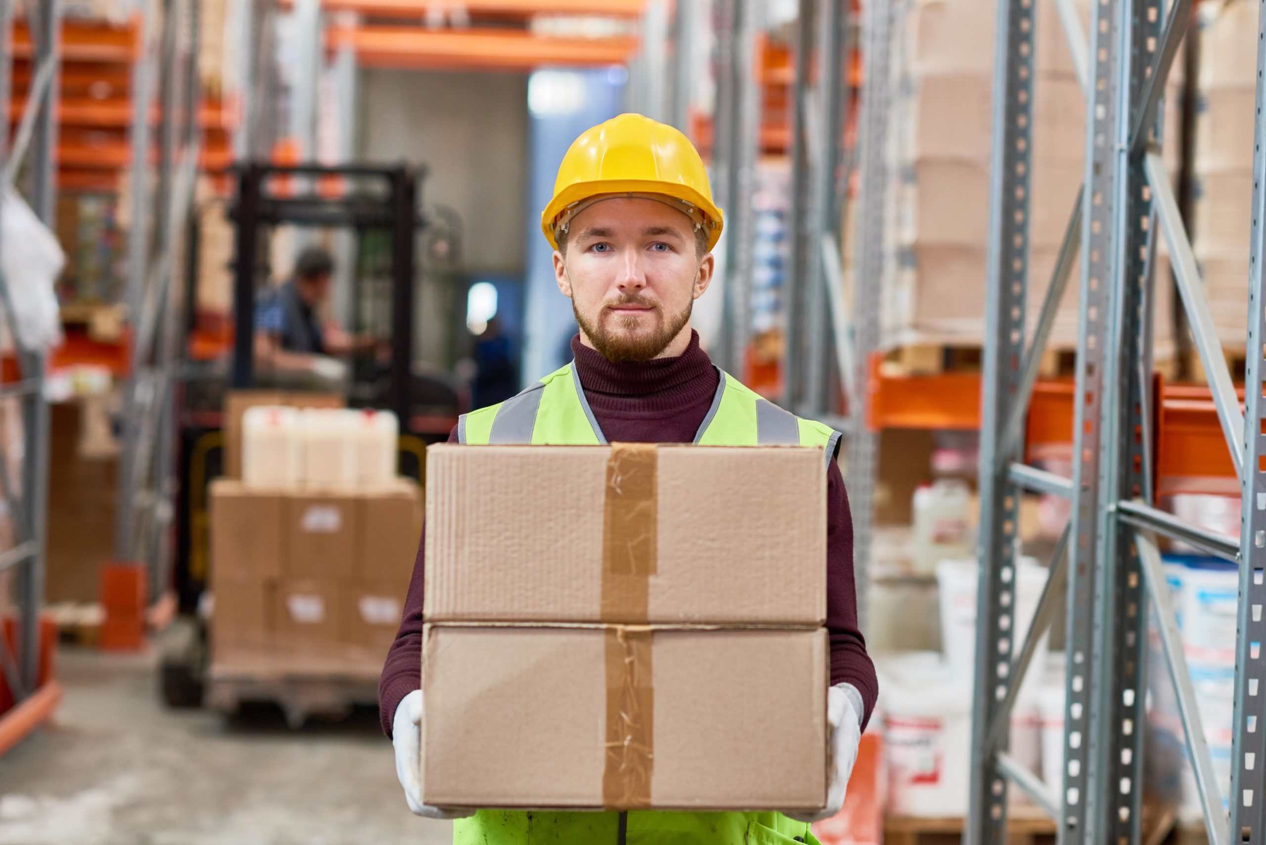 Shipping Worker Holding Boxes | Performance Plus Global Logistics